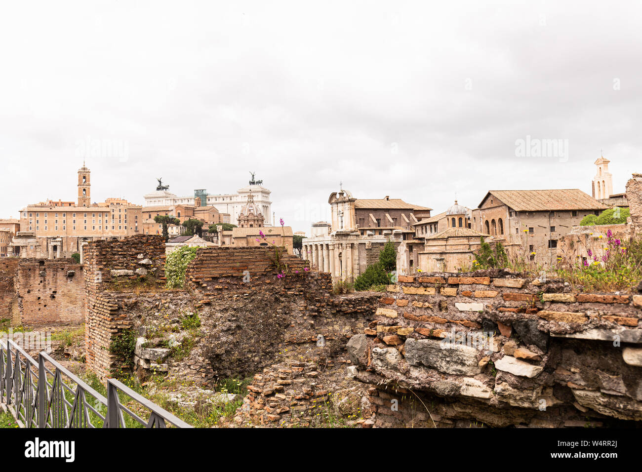 buildings and ruined bricked walls under grey sky in rome, italy Stock ...