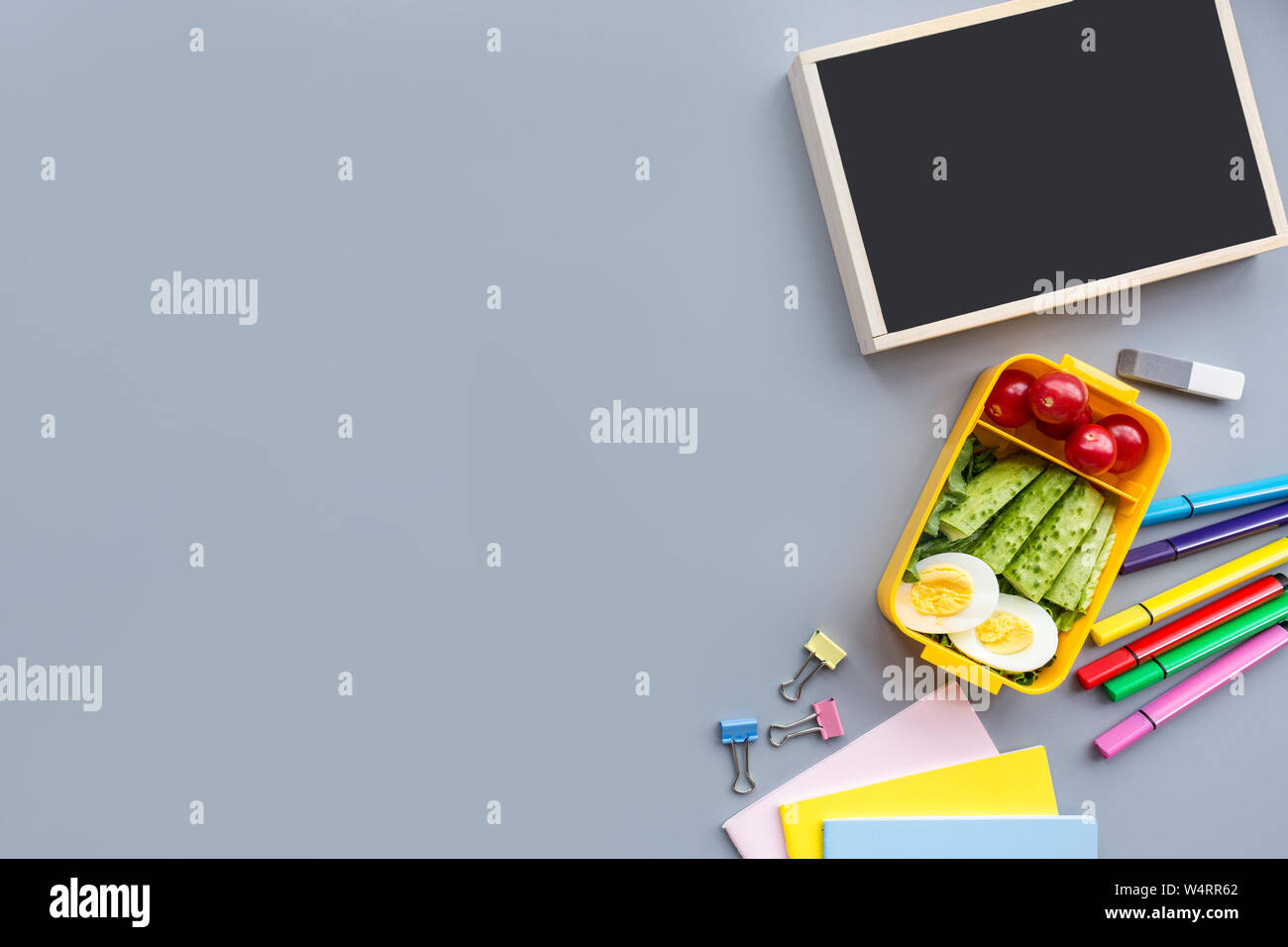 School supplies and lunch box with sandwich and vegetables. Back to ...