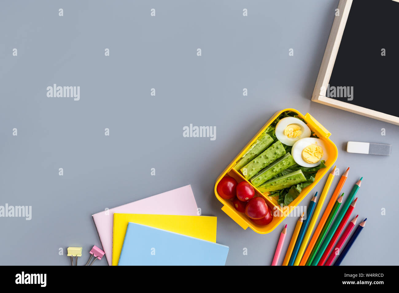 School supplies and lunch box with sandwich and vegetables. Back to ...