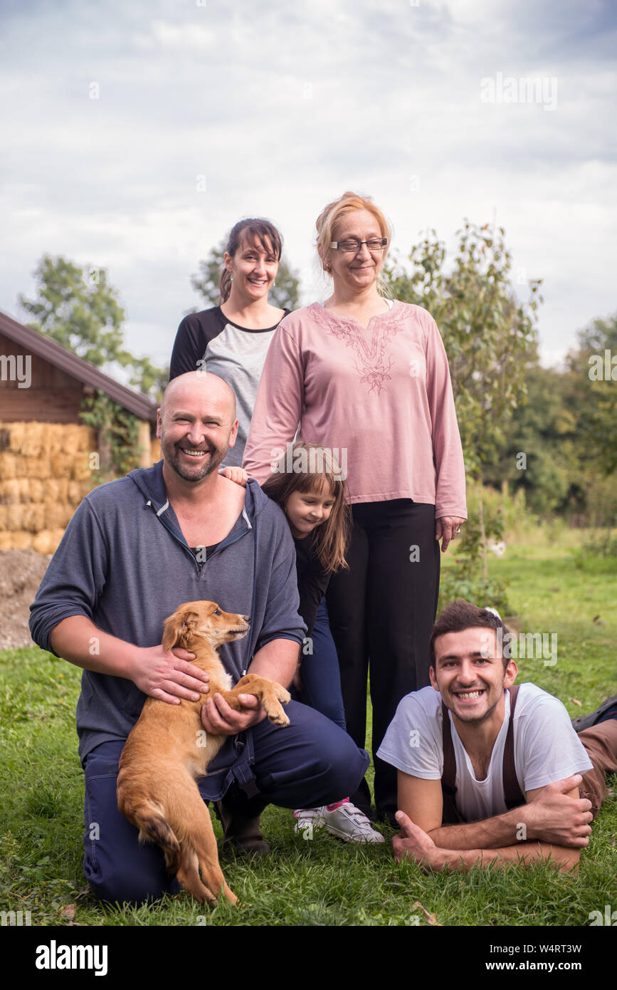 portrait of happy three generations family with dog at beautiful ...