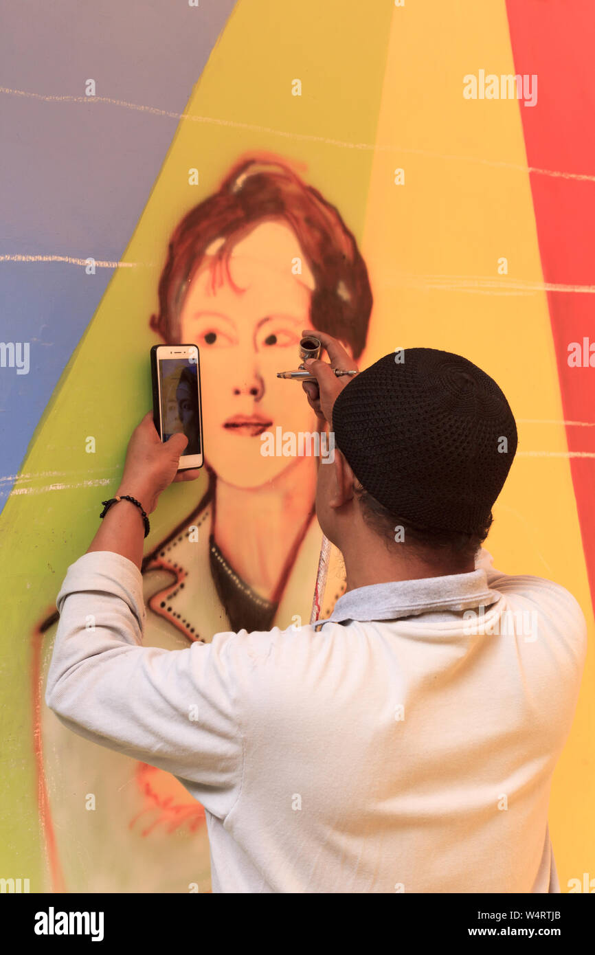 Street artist working in Kampung Warna Warni Jodipan Malang, Indonesia ...