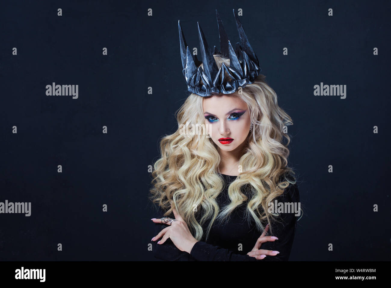 Portrait of a Gothic Queen. Beautiful young blonde woman in metal crown ...