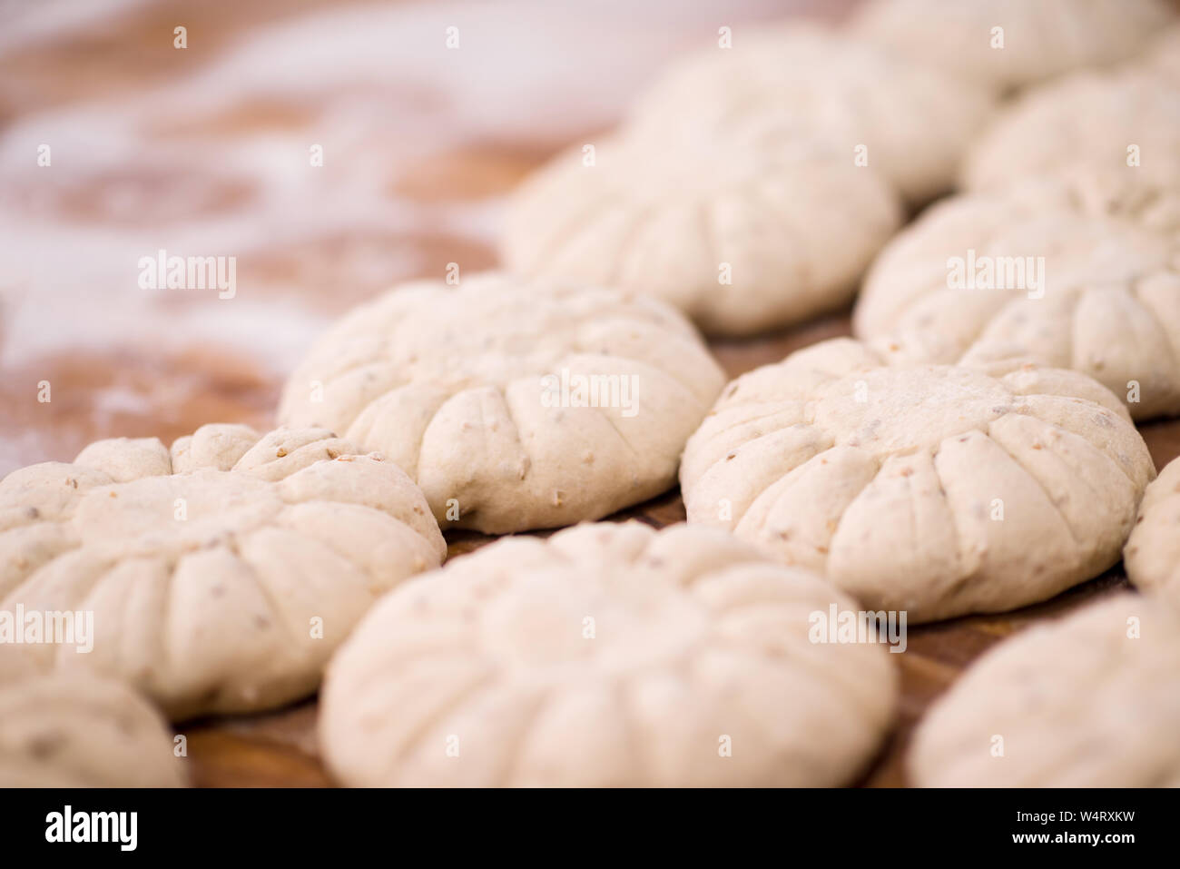balls of dough bread getting ready to be baked at professional bakery ...