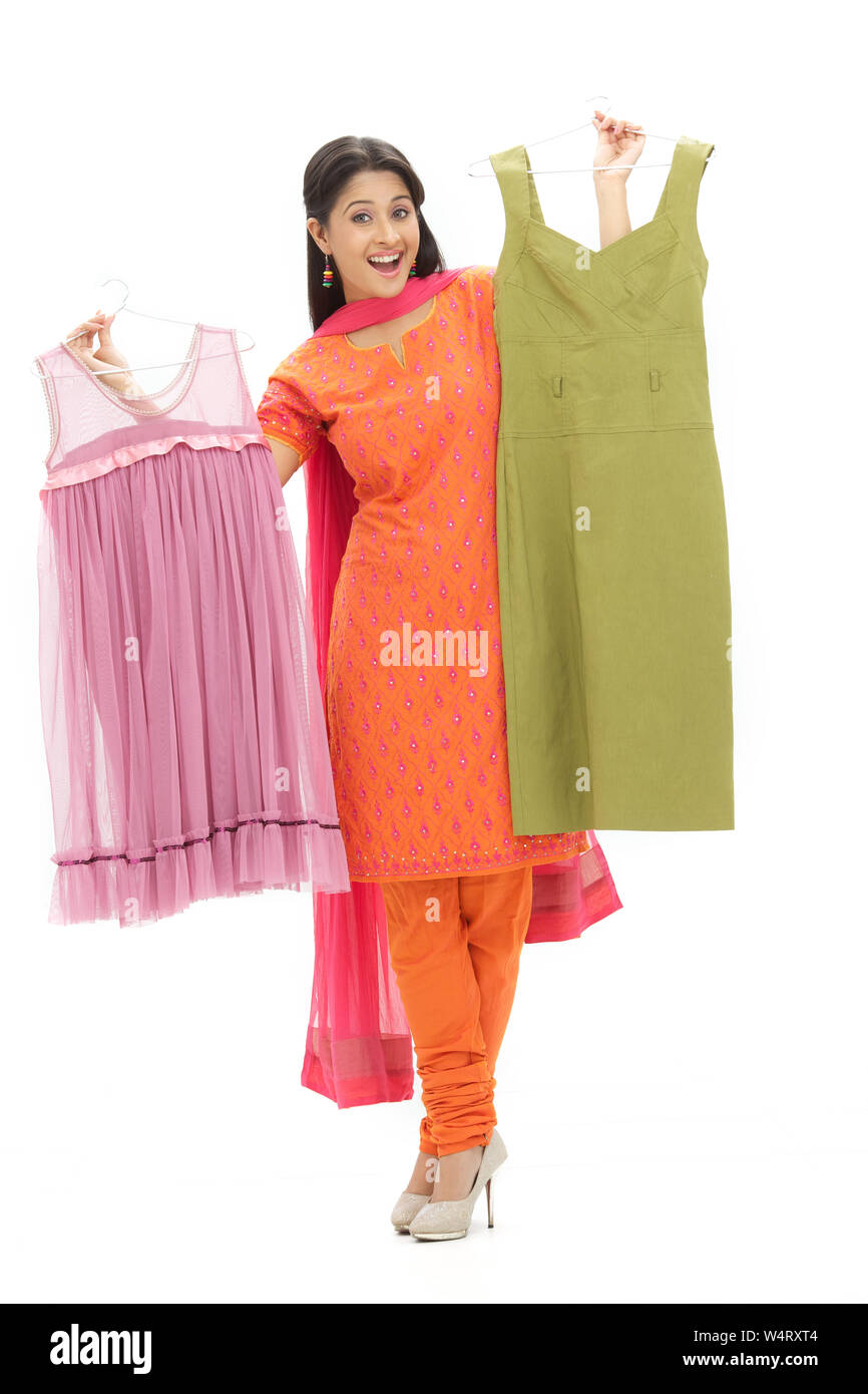 Woman choosing dress and smiling Stock Photo - Alamy