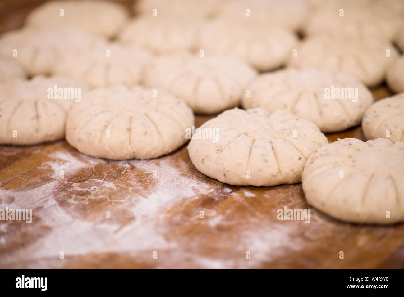 balls of dough bread getting ready to be baked at professional bakery ...