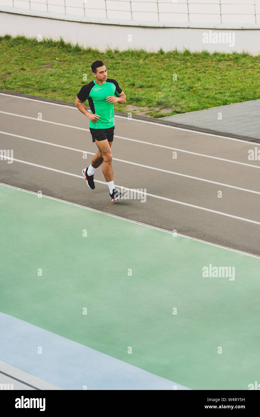 full length view of mixed race sportsman running at stadium Stock Photo ...