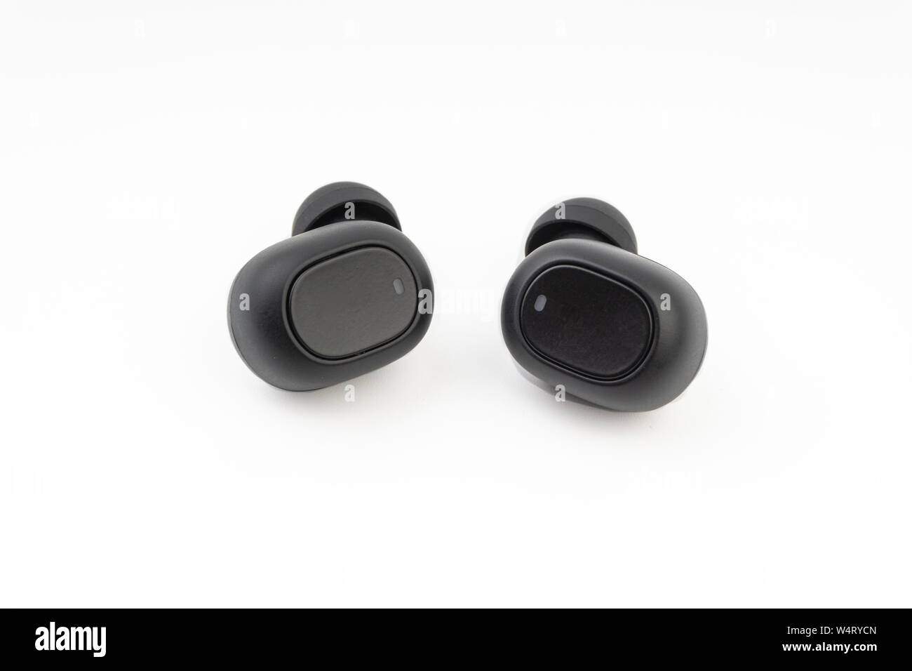 Wireless earbuds or earphones on white background Stock Photo - Alamy