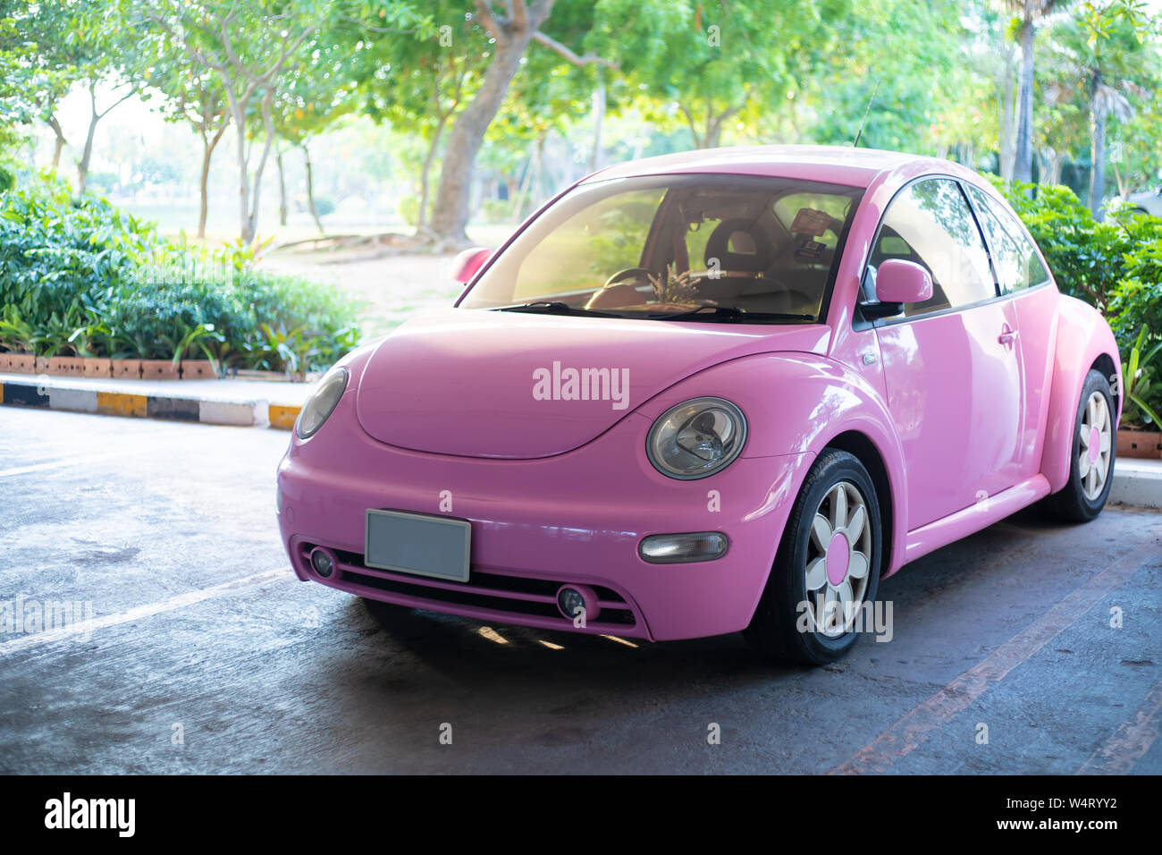 Modern fun pink small car. Photo of a modern funky pink car parked ...