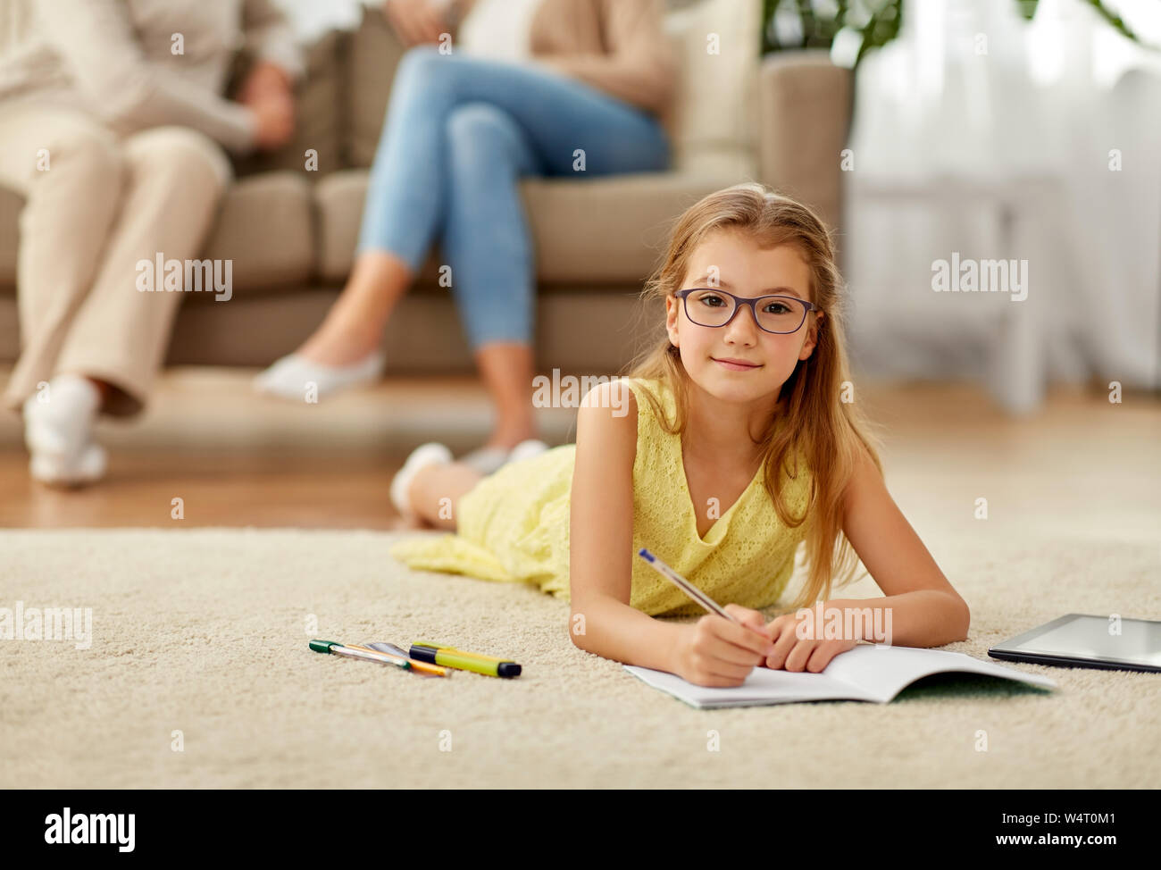 student girl writing to notebook at home Stock Photo - Alamy