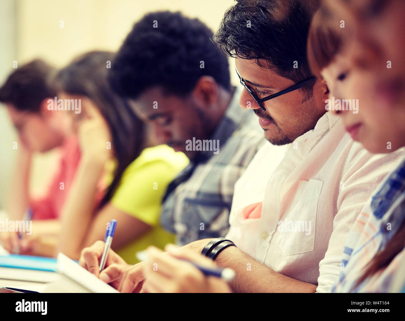 Multiethnic students writing test hi-res stock photography and images ...