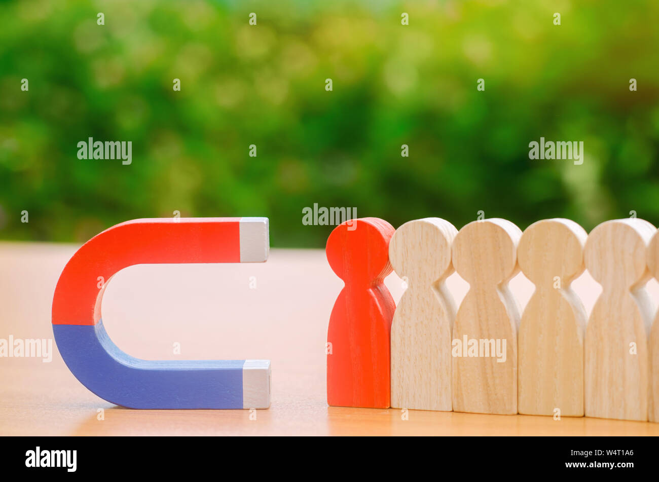 Wooden figures of people and a magnet. Team management concept. Human ...