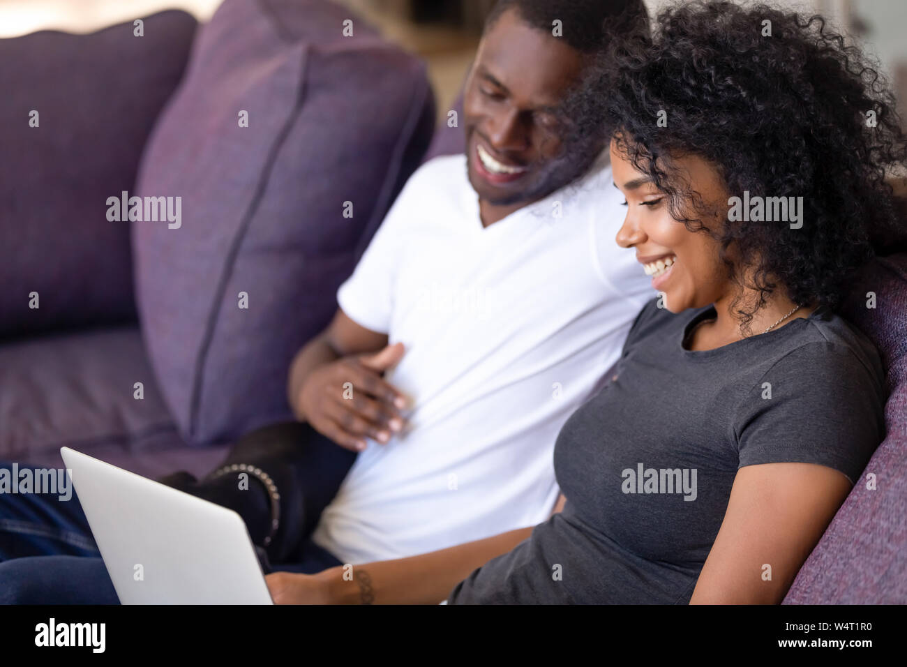 Focus on african female spend time with husband using computer Stock ...