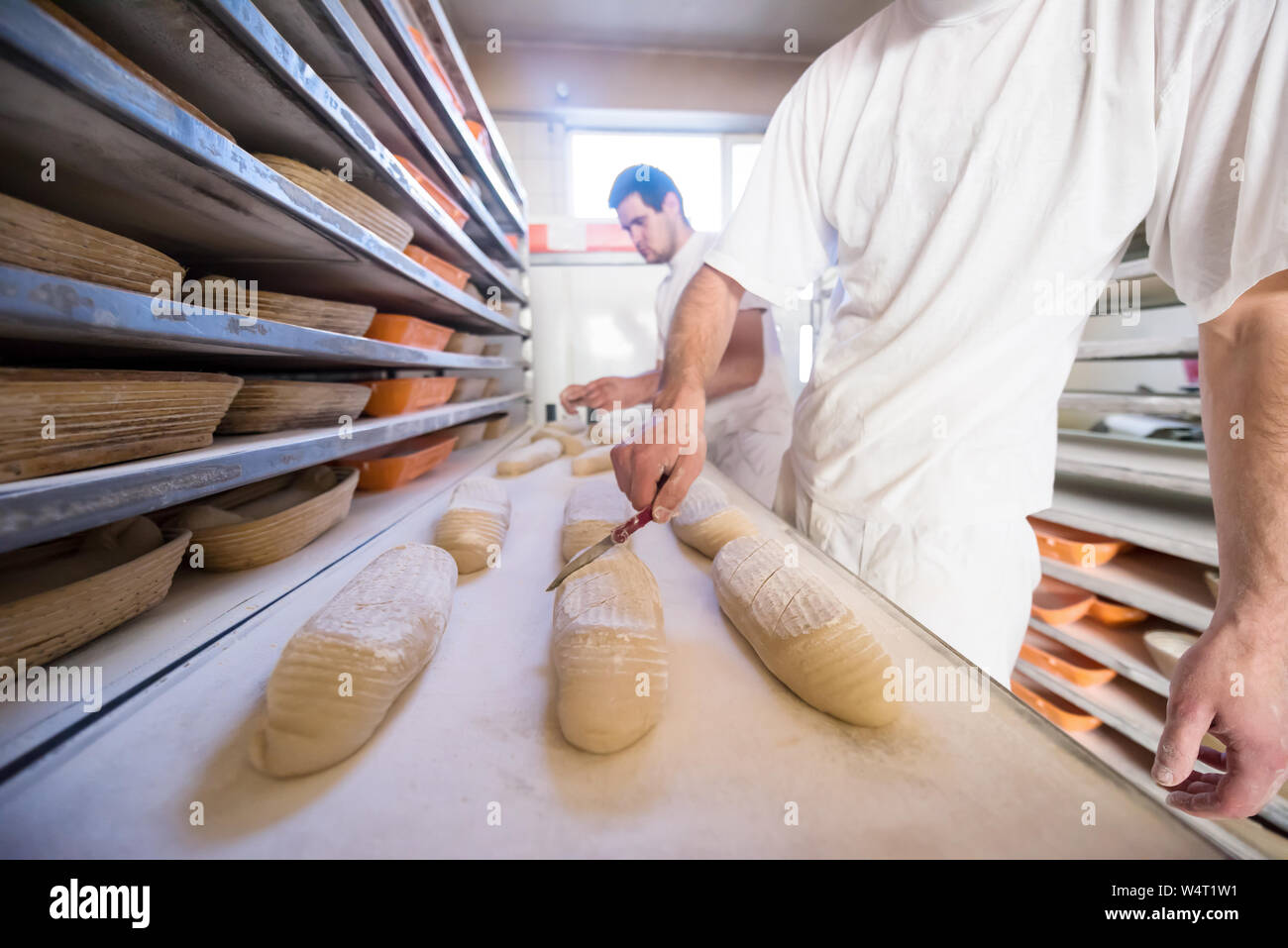 bakers preparing the dough for products In a traditional bakery Stock ...