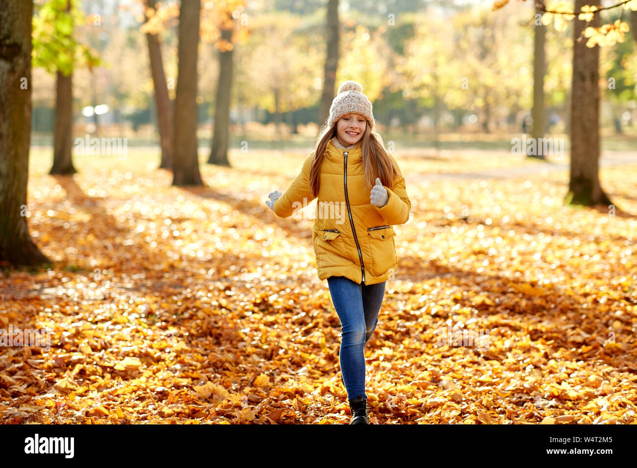 happy girl running in autumn park Stock Photo - Alamy