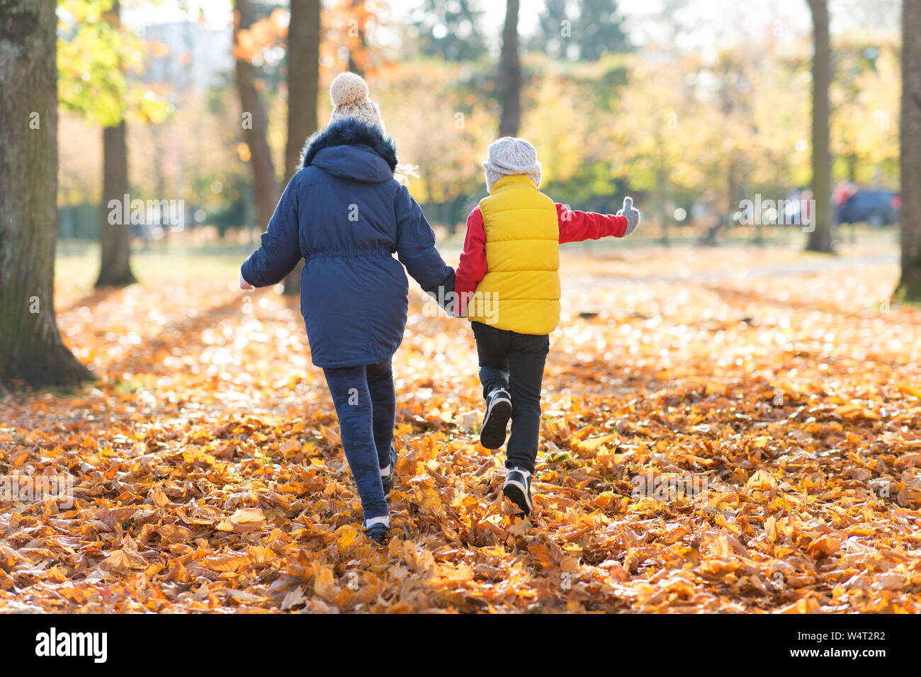 happy children running at autumn park Stock Photo - Alamy