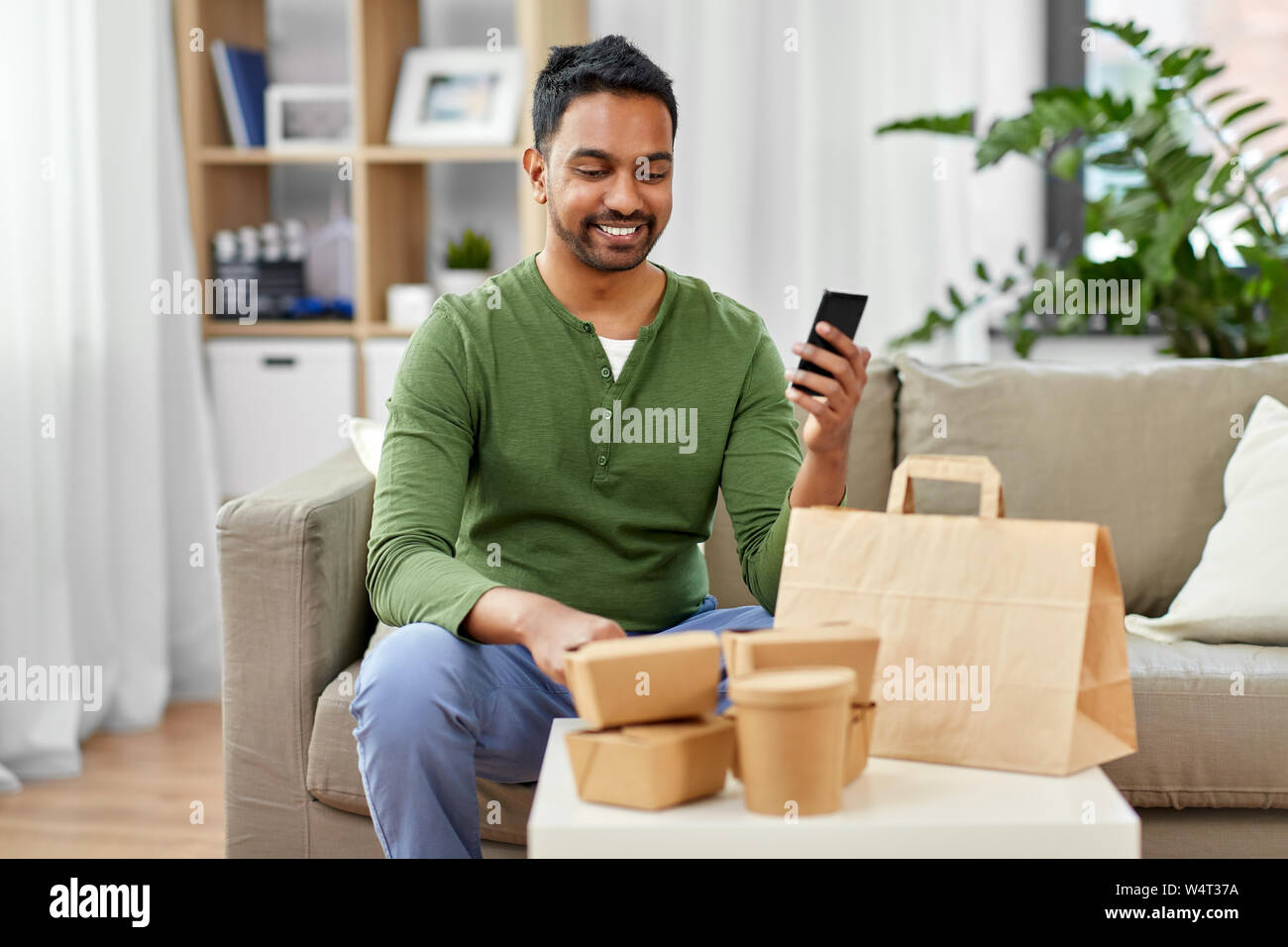 indian man using smartphone for food delivery Stock Photo - Alamy