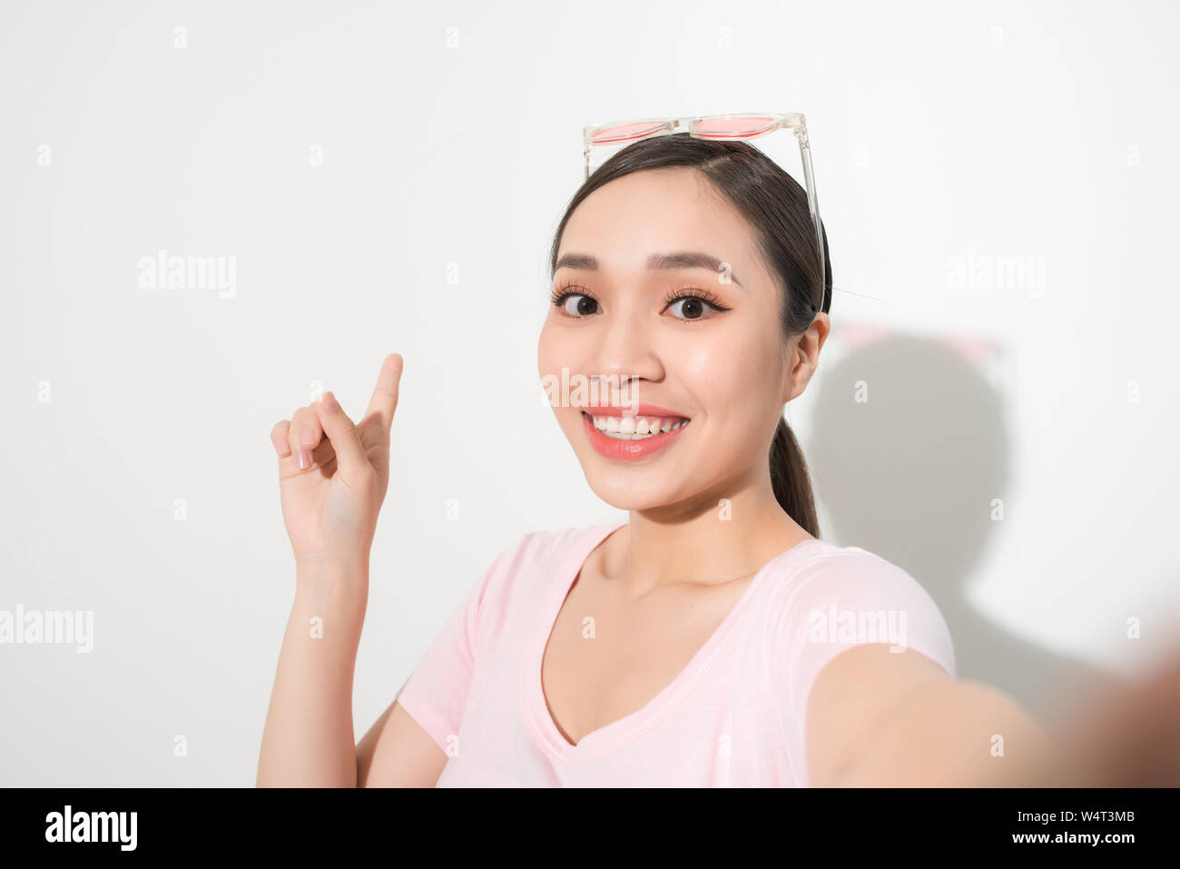 Young happy smile girl take selfie on white background Stock Photo - Alamy