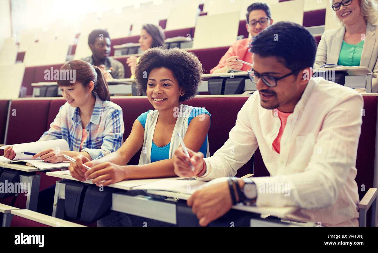 group of students with notebooks in lecture hall Stock Photo - Alamy