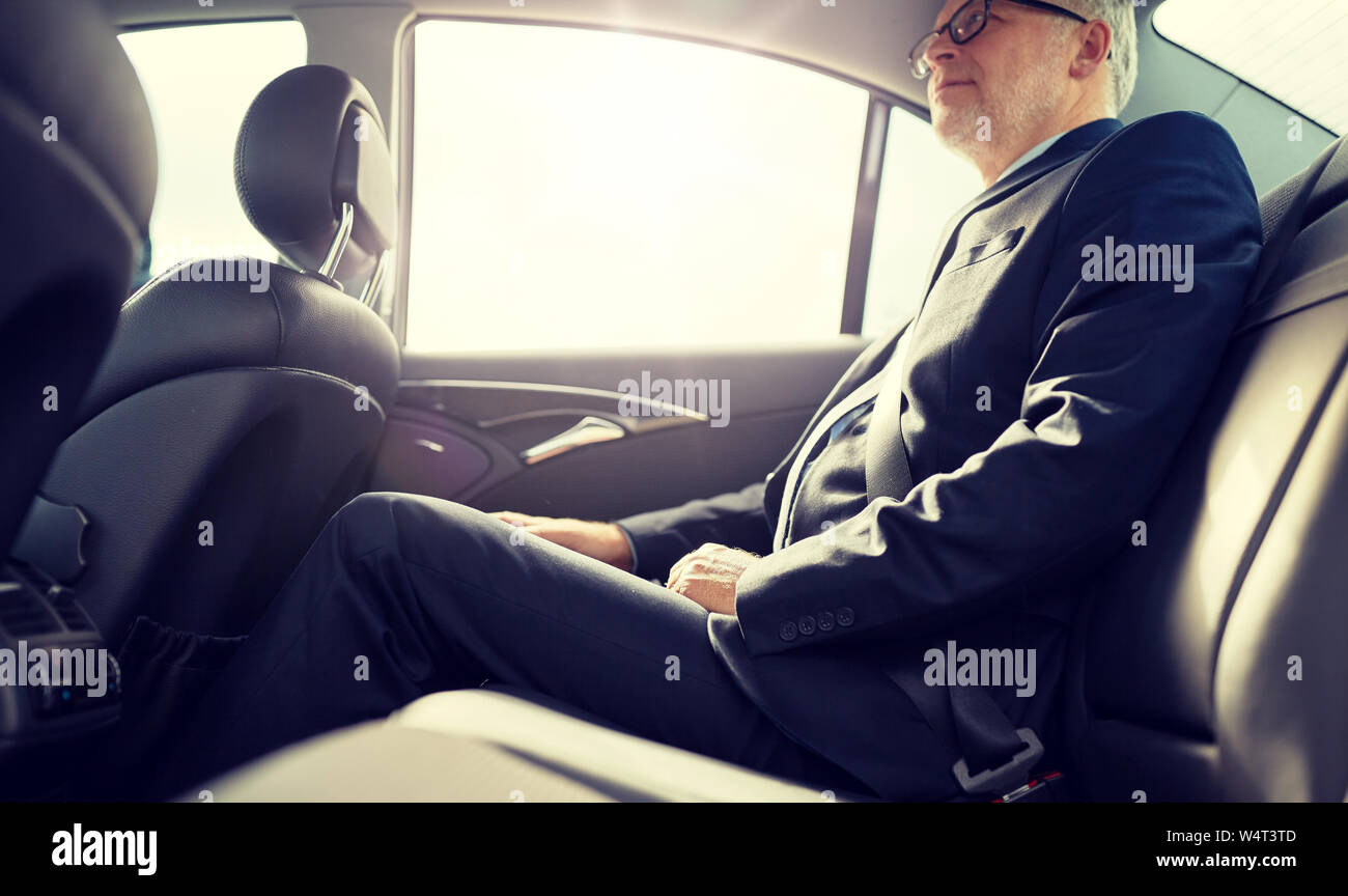 senior businessman driving on car back seat Stock Photo - Alamy