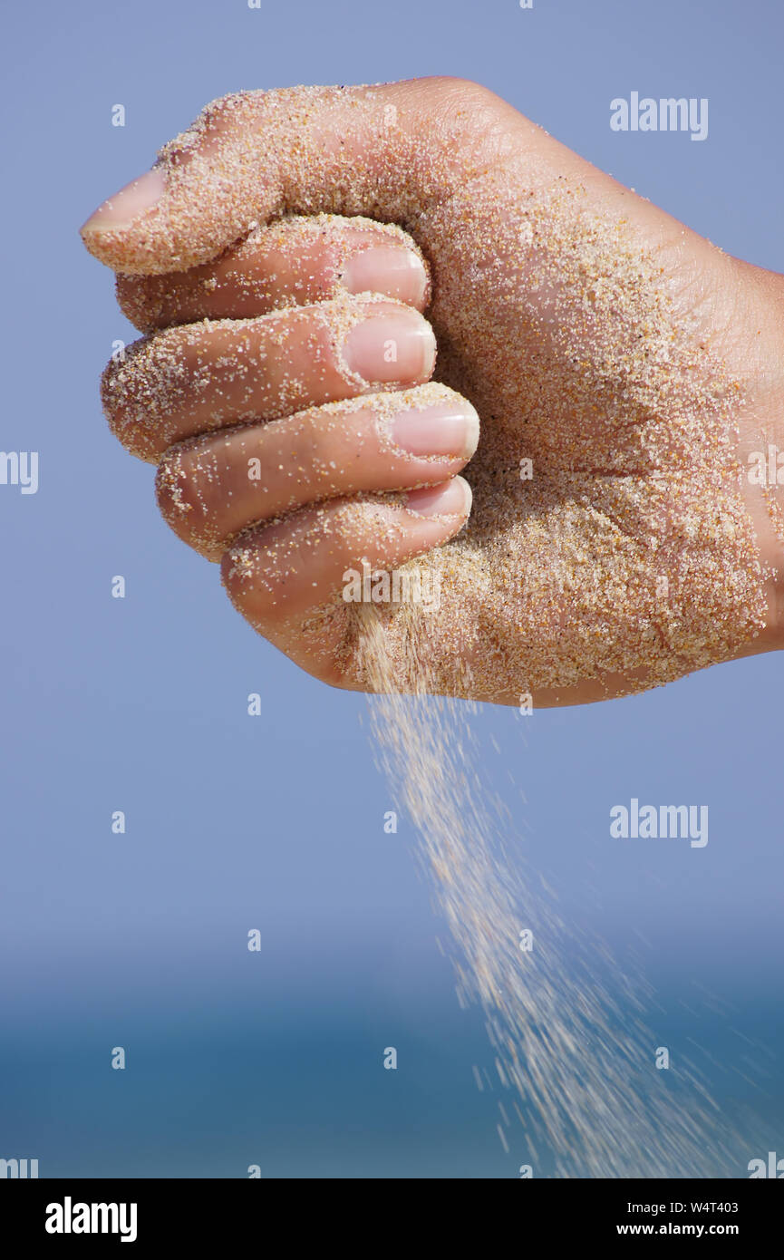 sand running through hands as a symbol for time running, lost Stock ...