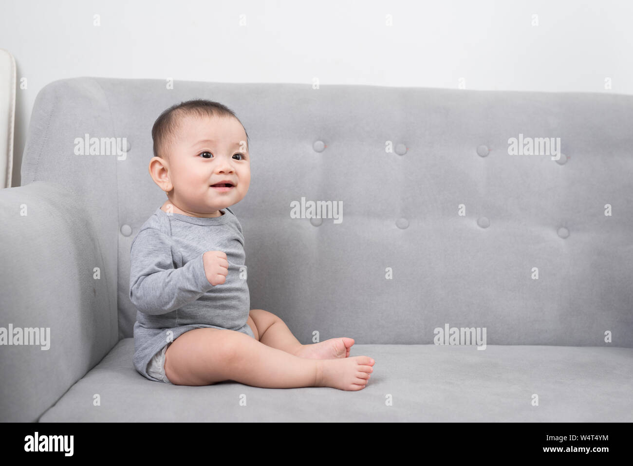 childhood, babyhood and people concept - happy little baby girl sitting ...