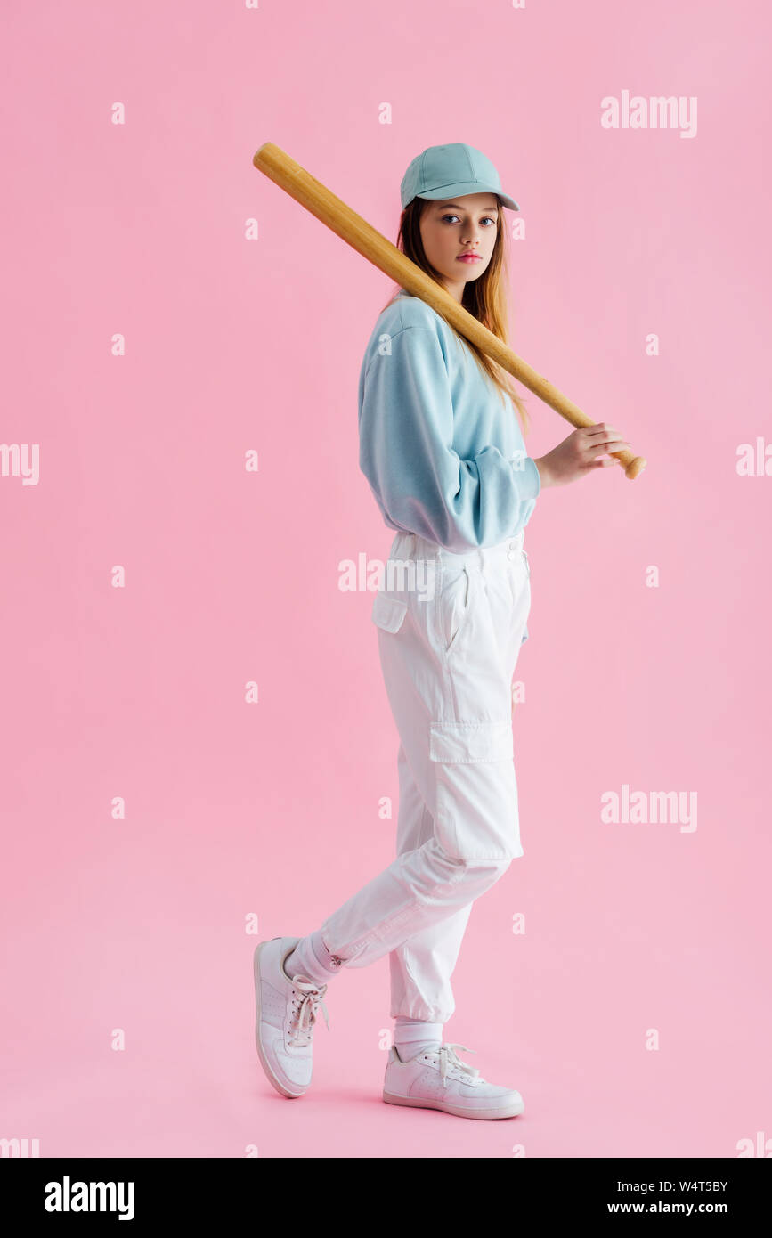 pretty teenage girl in cap holding baseball bat on pink Stock Photo - Alamy