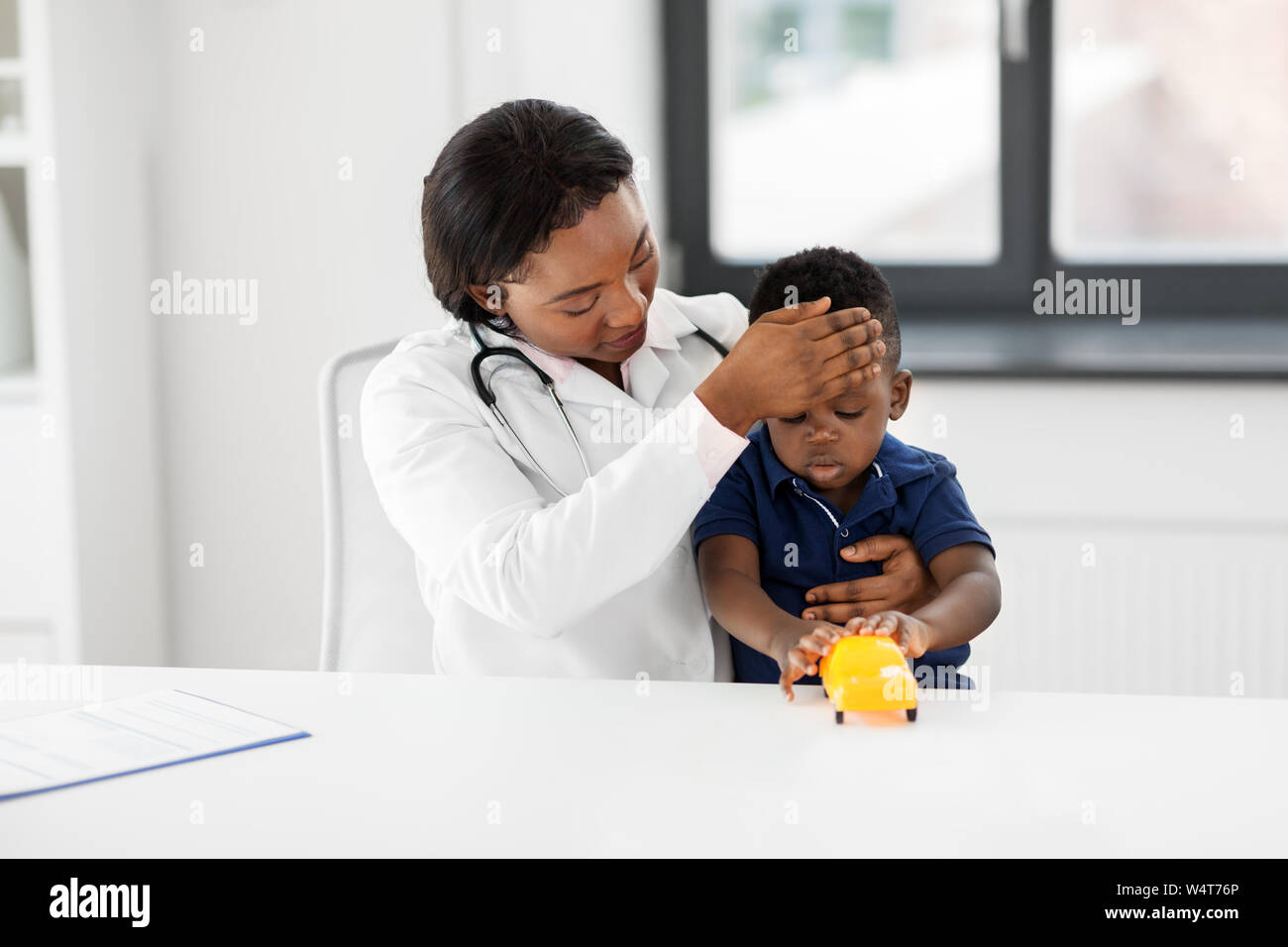 doctor with measuring baby's temperature at clinic Stock Photo - Alamy