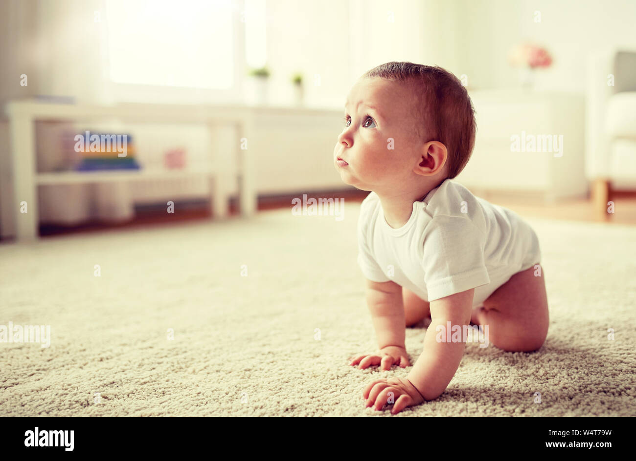 little baby in diaper crawling on floor at home Stock Photo - Alamy