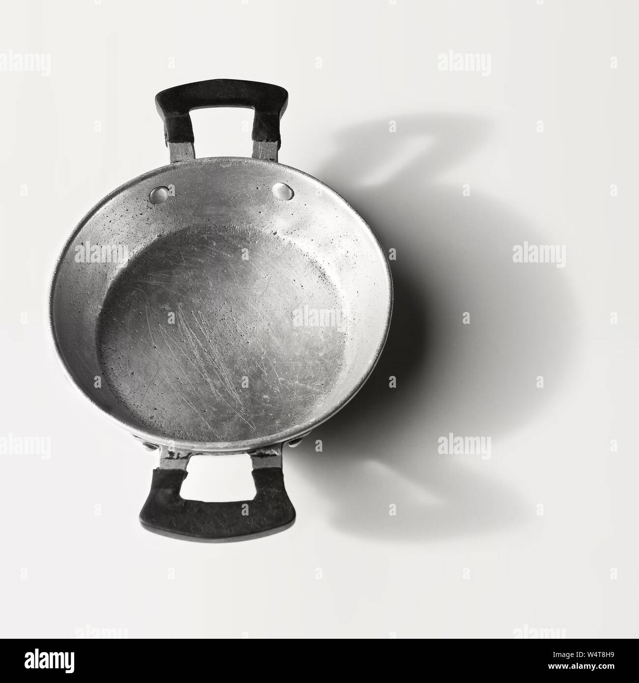 Old aluminum pan seen from above on white background Stock Photo - Alamy