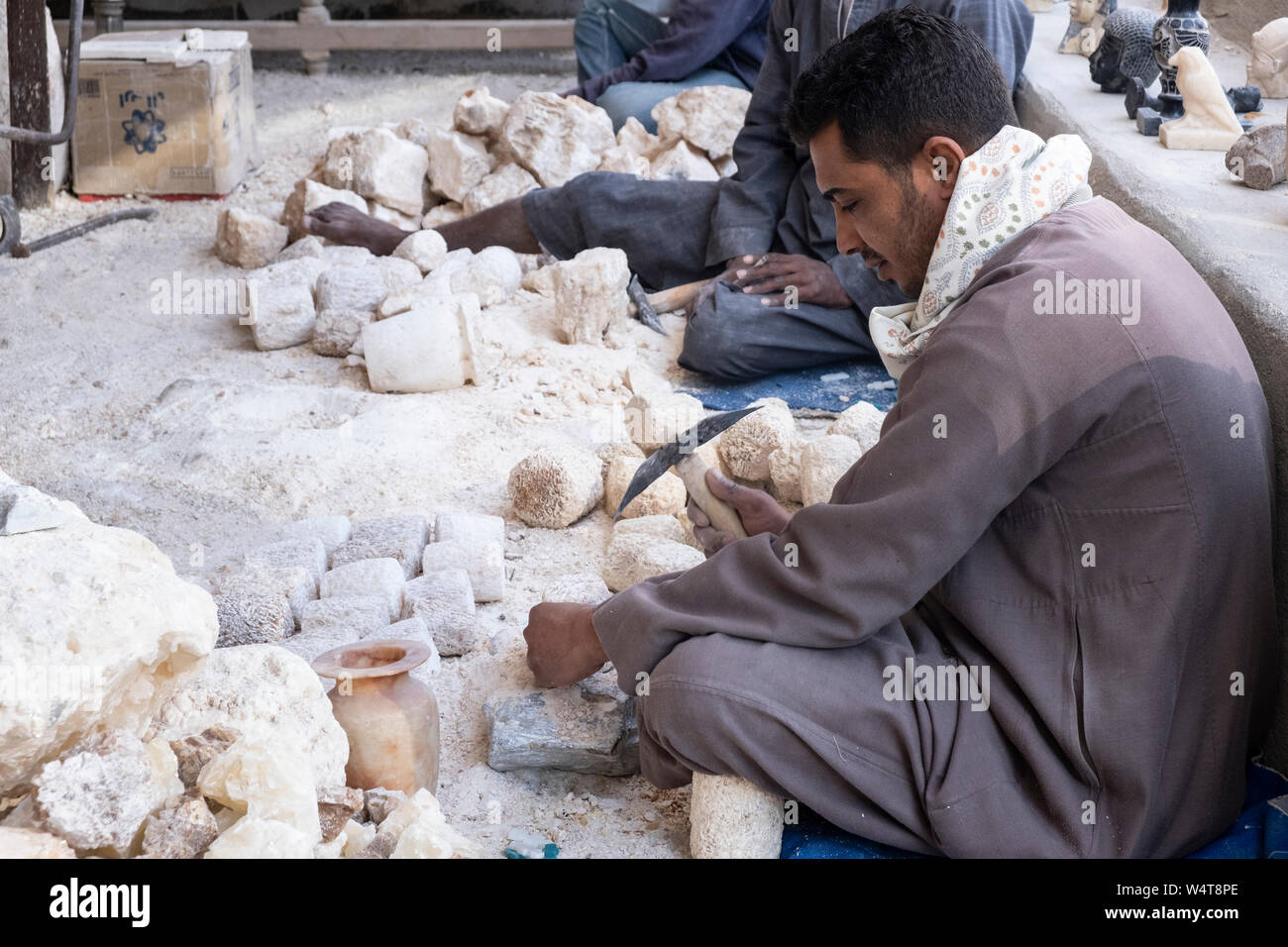 Stone carver at Valley of the Artisans, Luxor, Egypt. The craftsman is ...