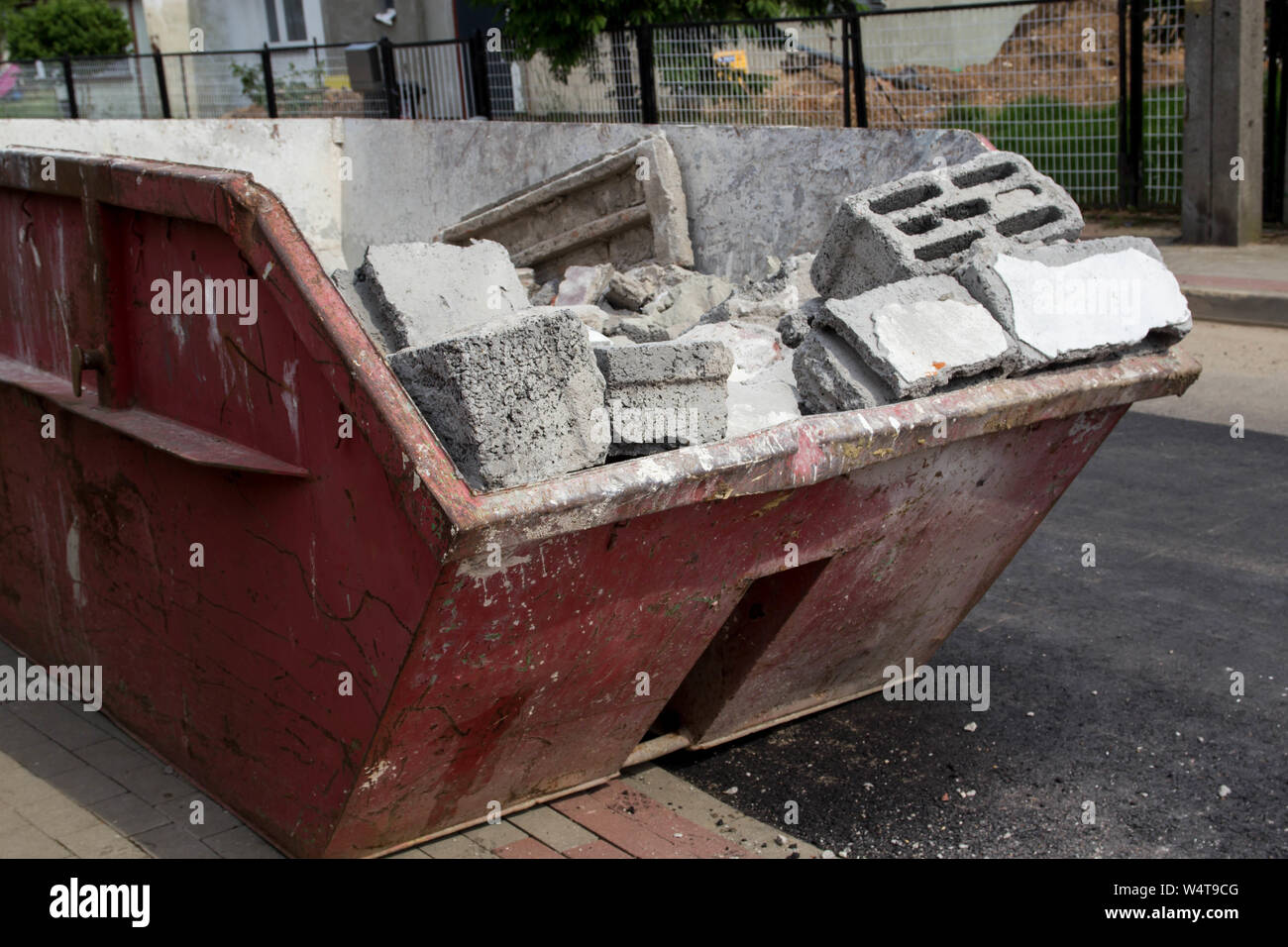 red container filled with debris after the building demolition ...