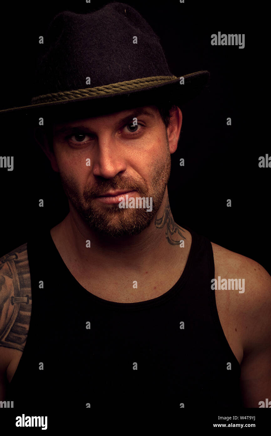low key portrait of young gangster with hat in the darkness Stock Photo ...