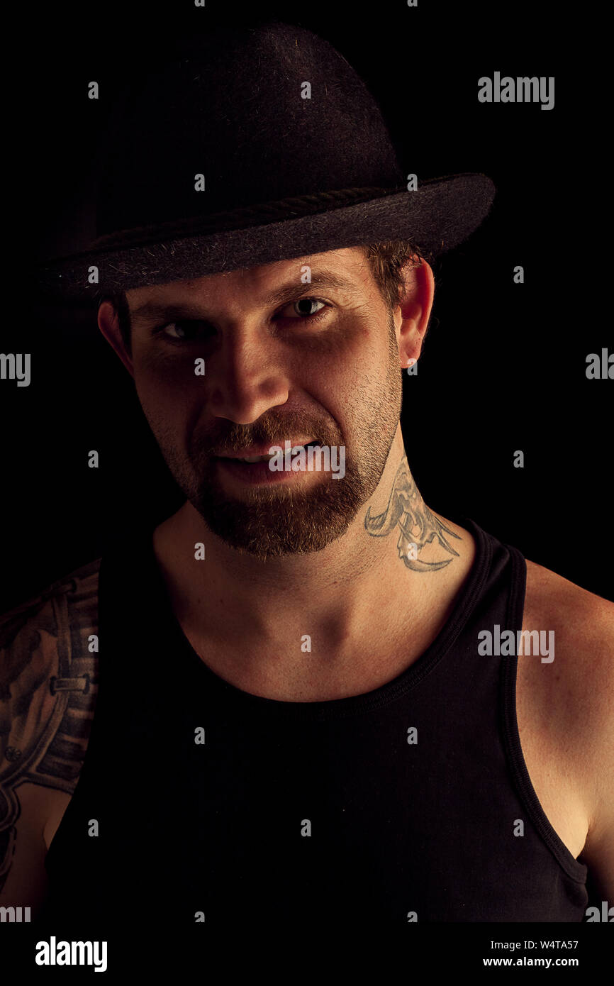 low key portrait of young gangster with hat in the darkness Stock Photo ...