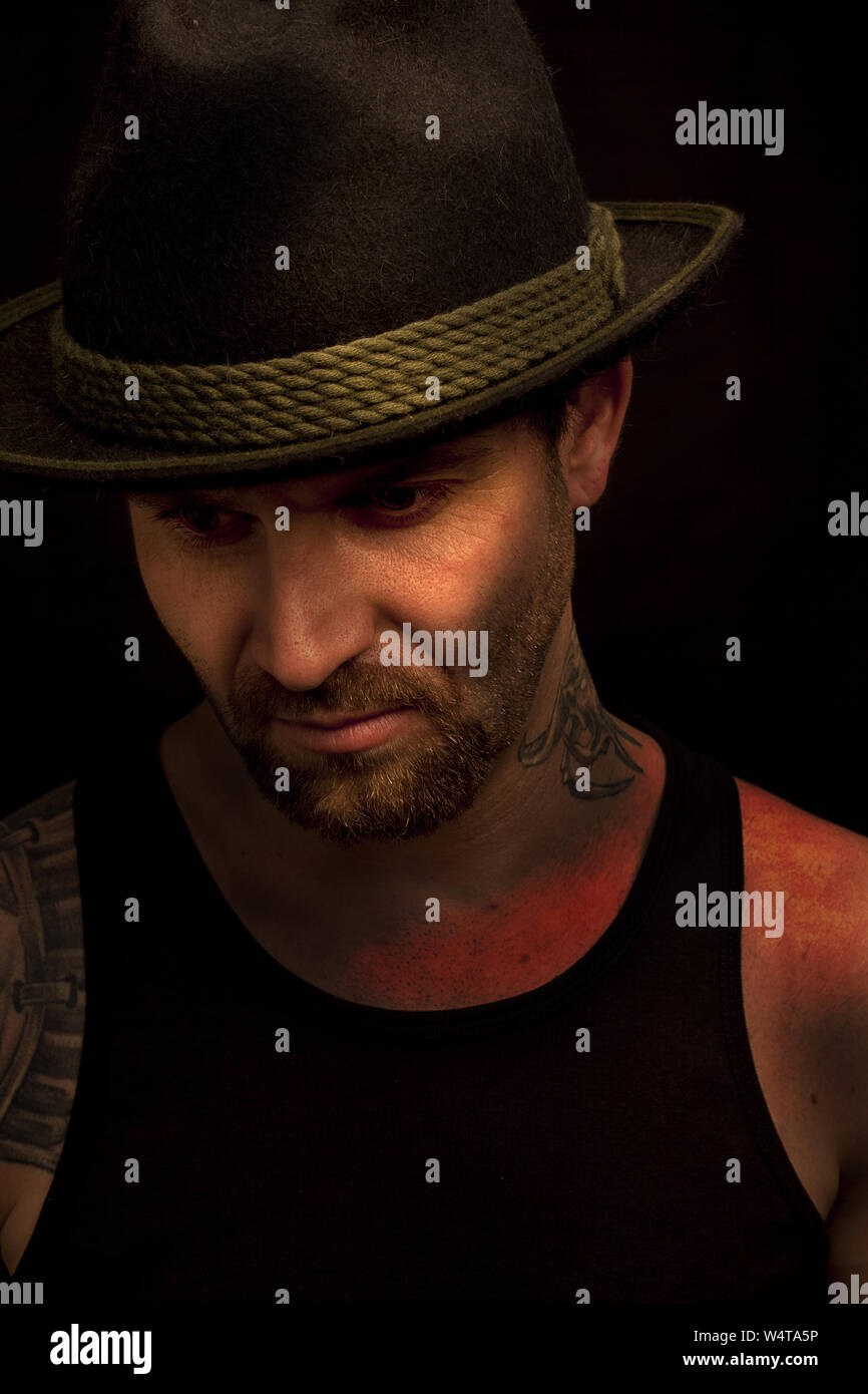 low key portrait of young gangster with hat in the darkness Stock Photo ...