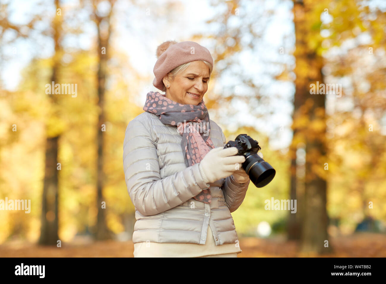 senior woman with photo camera at autumn park Stock Photo - Alamy
