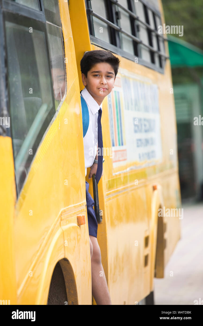 Indian schoolboy getting into the school bus Stock Photo - Alamy
