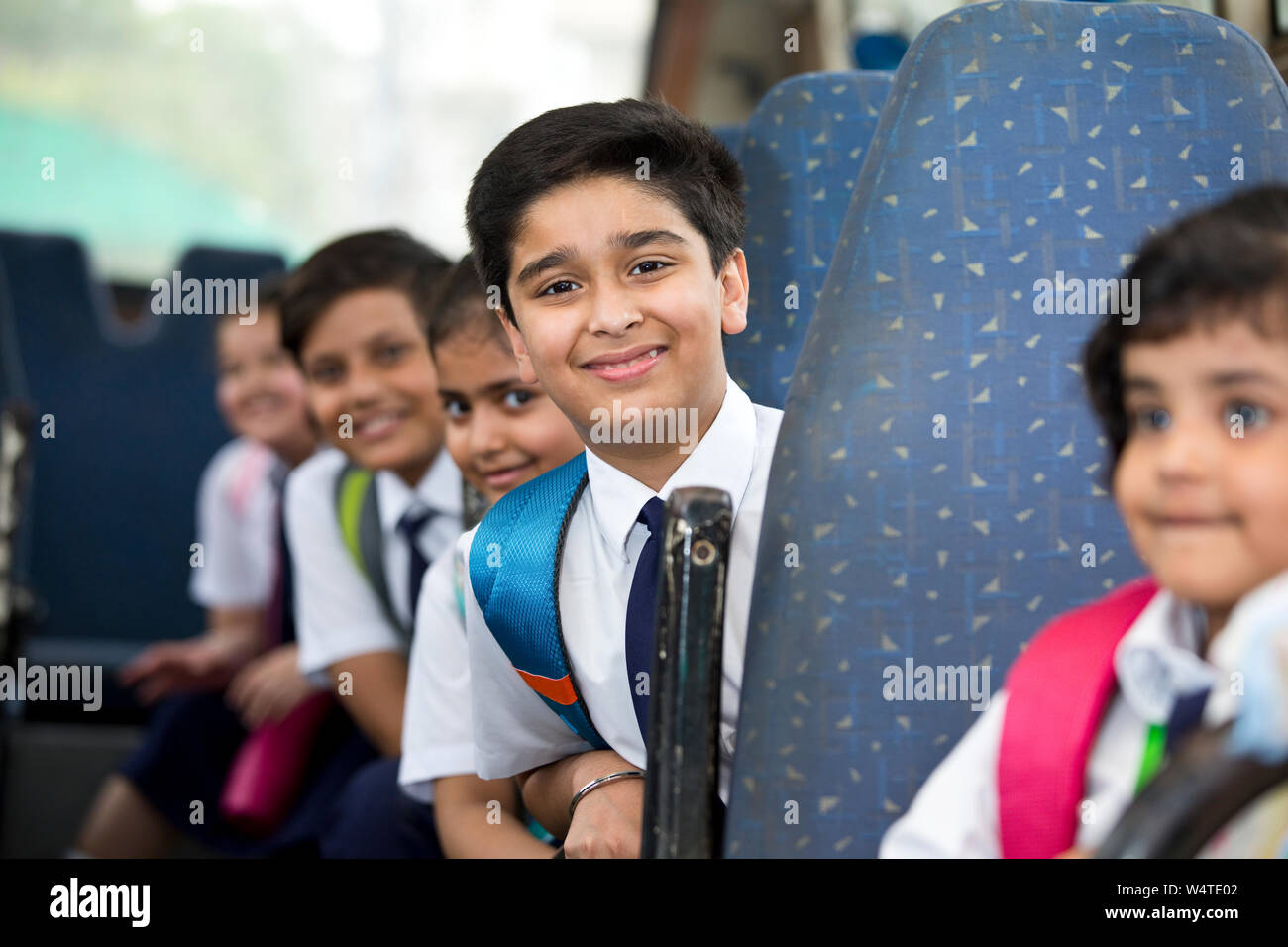 School children traveling in school bus looking at camera Stock Photo ...
