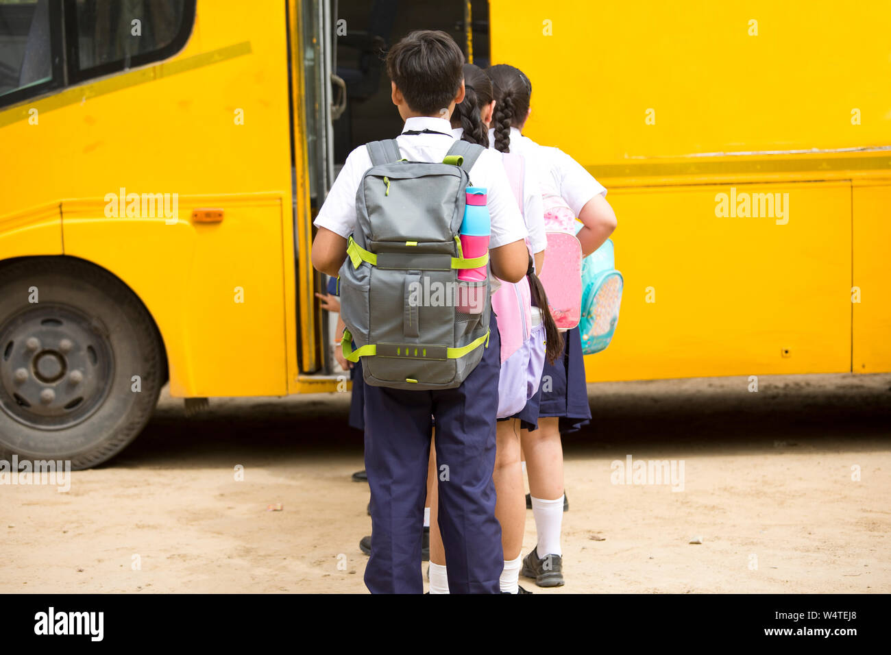 Group of school children boarding the school bus Stock Photo - Alamy