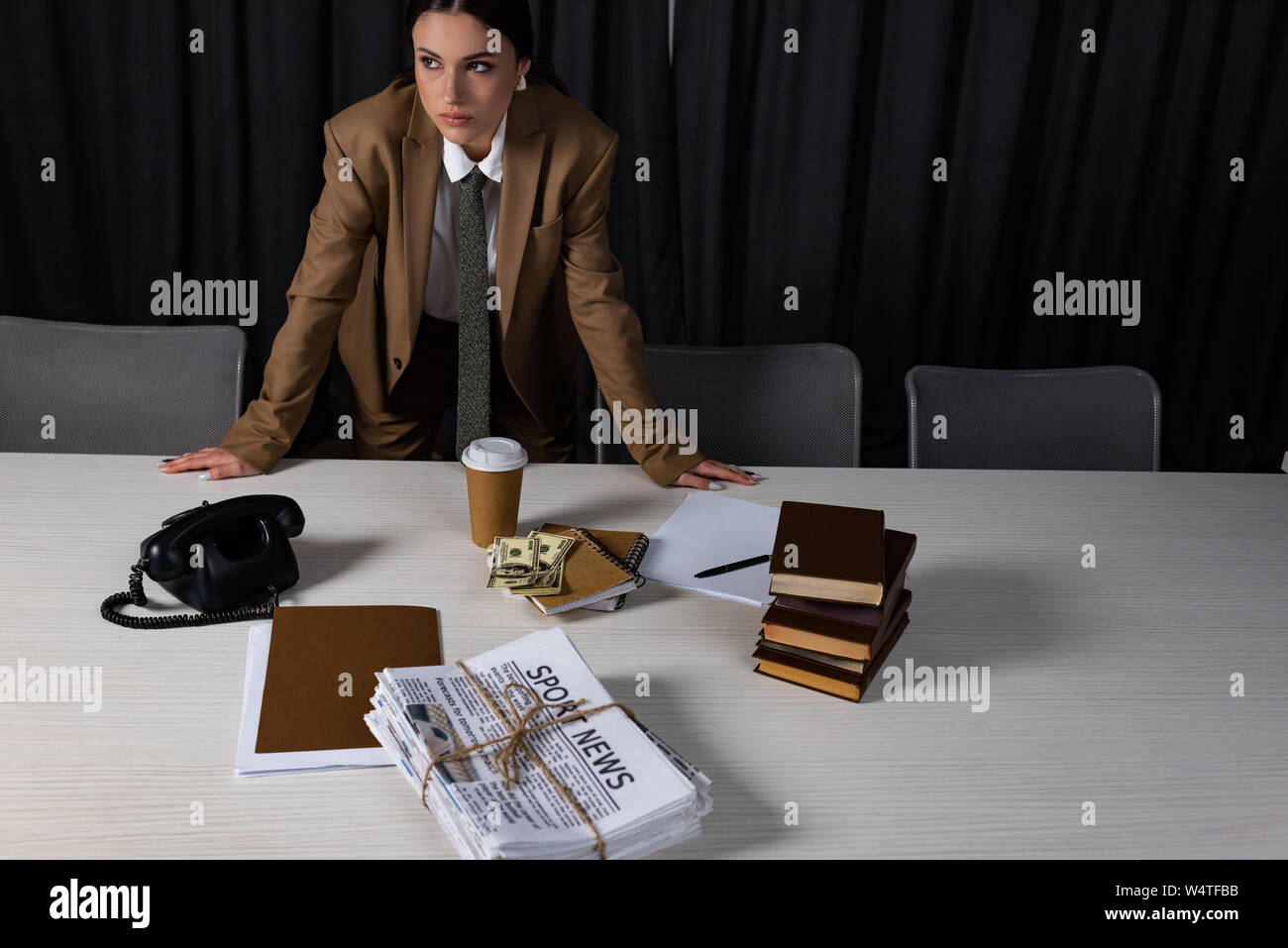 successful and beautiful businesswoman standing behind table in office ...