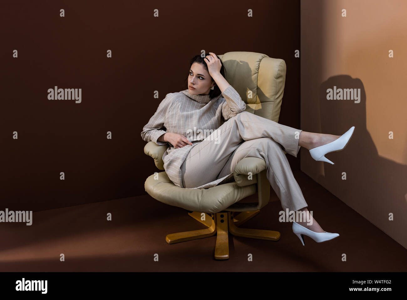 Young woman crossing legs model hi-res stock photography and images - Alamy