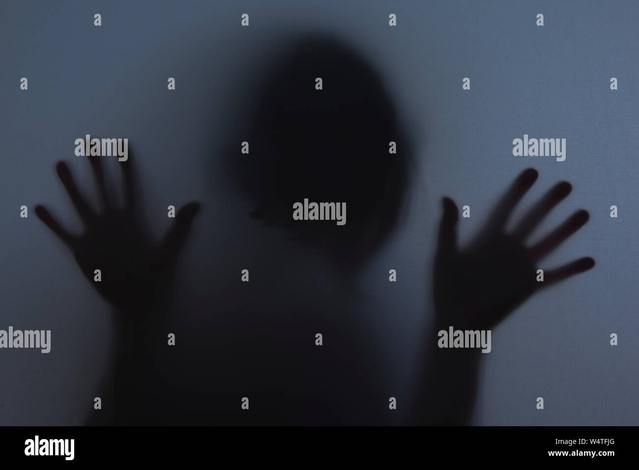 Shadowy figure behind glass / fear, panic concept Stock Photo - Alamy
