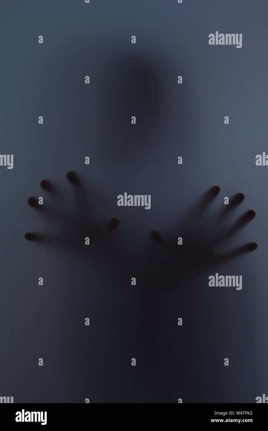 Shadowy figure behind glass / fear, panic concept Stock Photo - Alamy