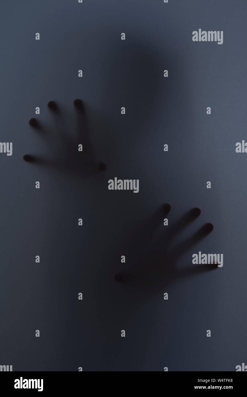 Shadowy figure behind glass / fear, panic concept Stock Photo - Alamy