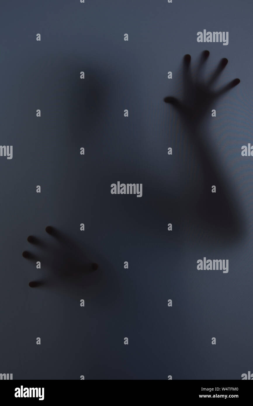 Shadowy figure behind glass / fear, panic concept Stock Photo - Alamy