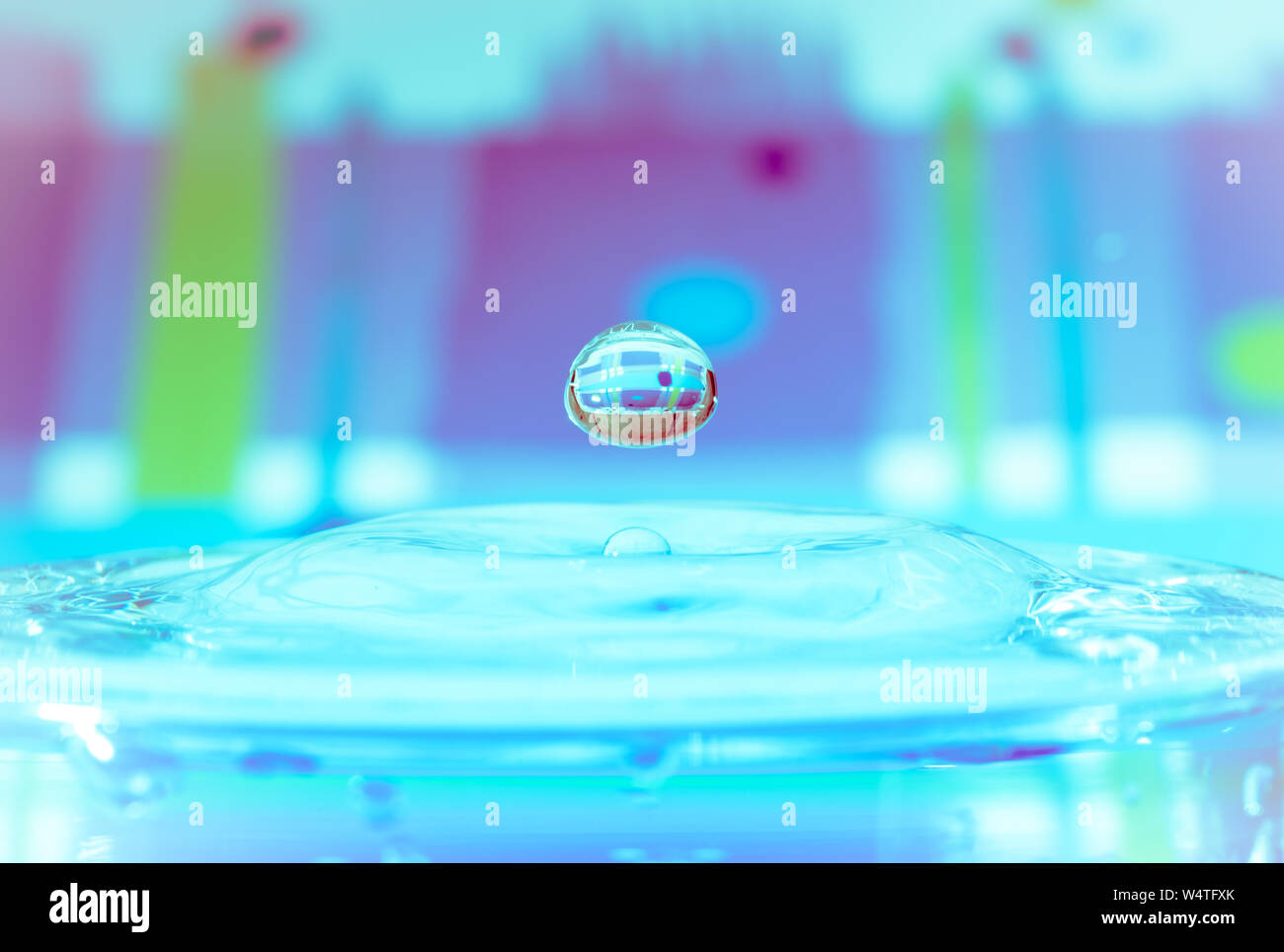 Falling water drop on ocean blue background Stock Photo - Alamy