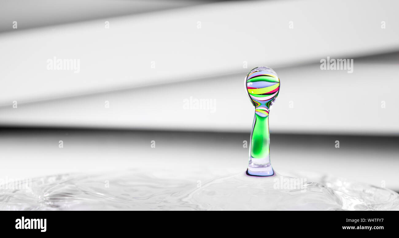 Water droplet with colourful stripes on monochrome background Stock ...
