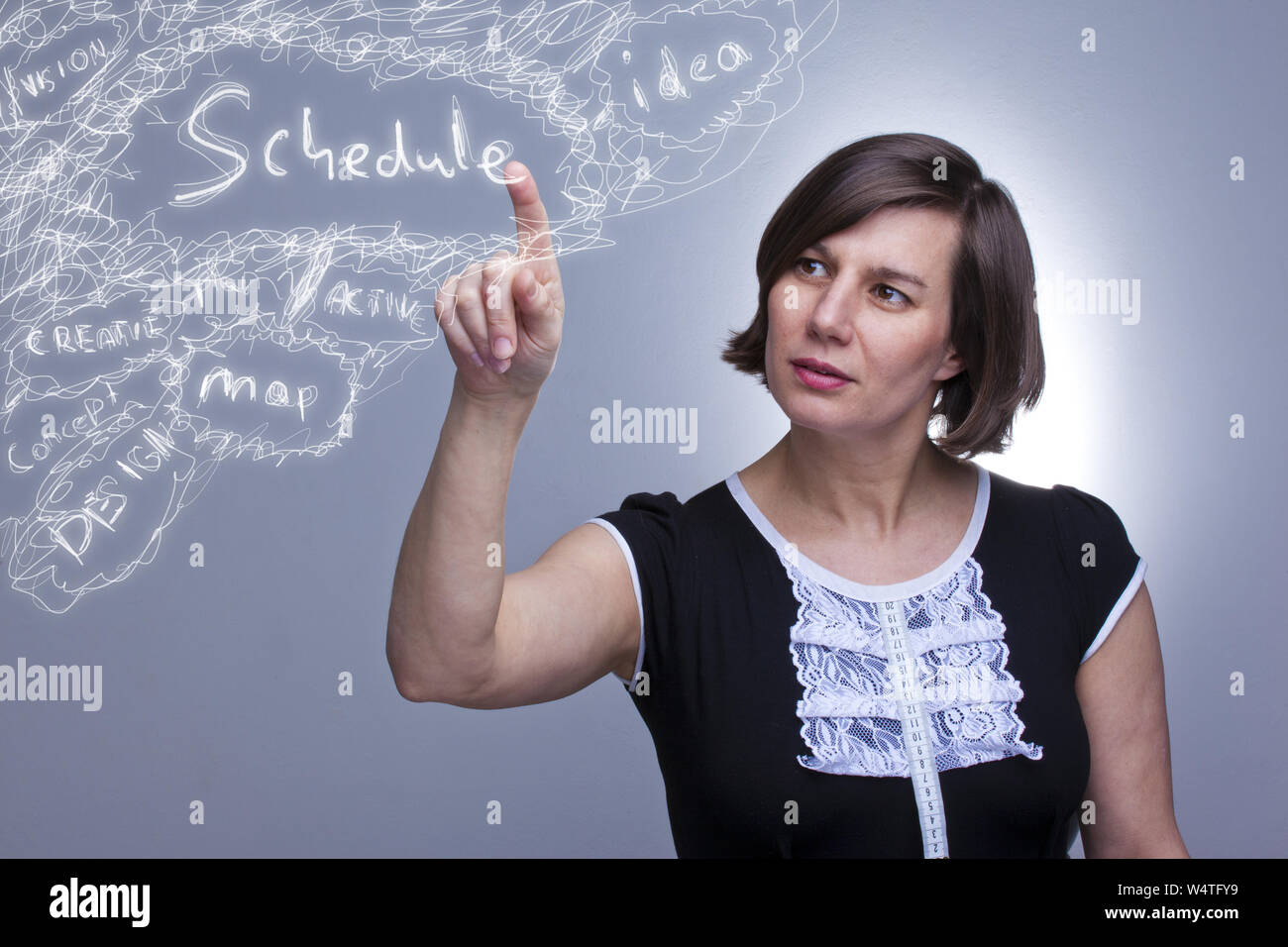 Woman drawing a future schedule by touching screen Stock Photo - Alamy