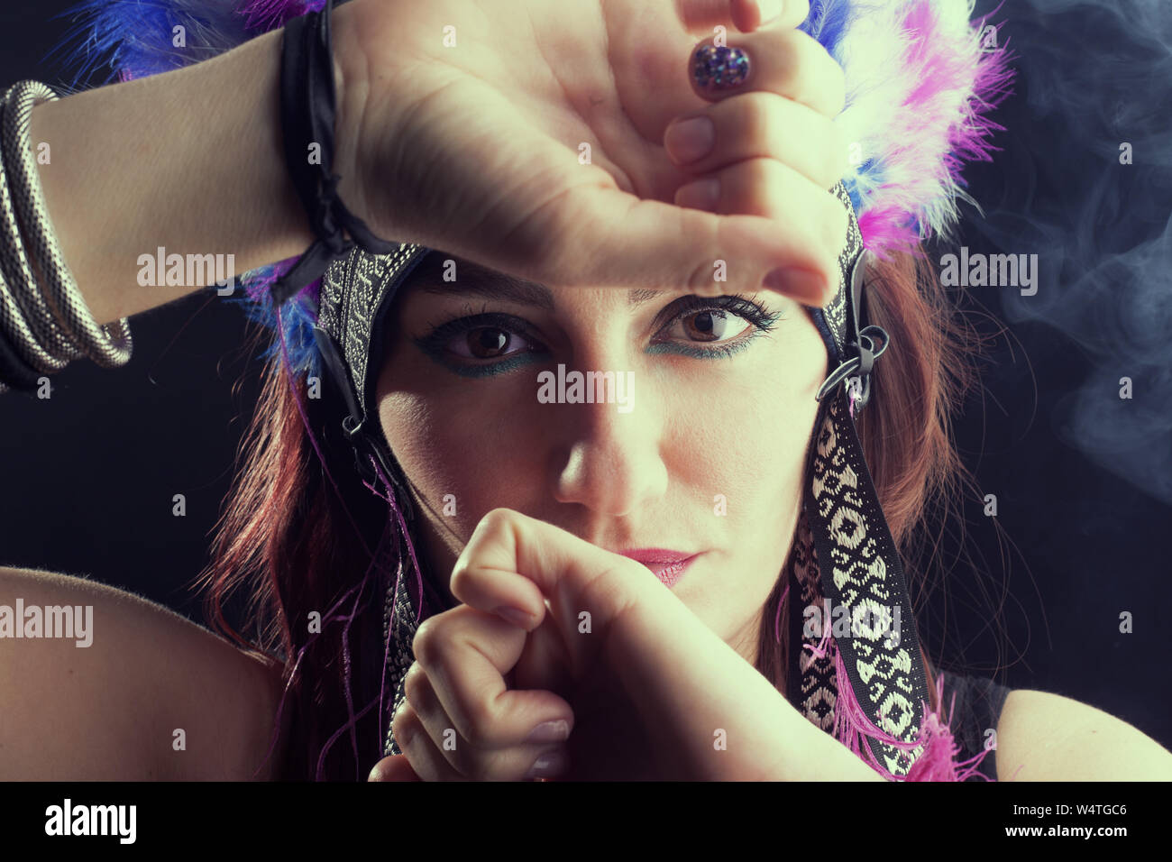 woman shaman or brasilian dancers in the smoke on black backgroung ...