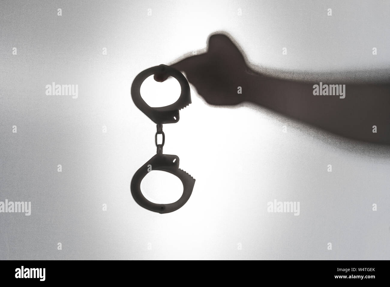 Handcuff ready for criminals. Arrest concept. Silhouette of sheriff's ...