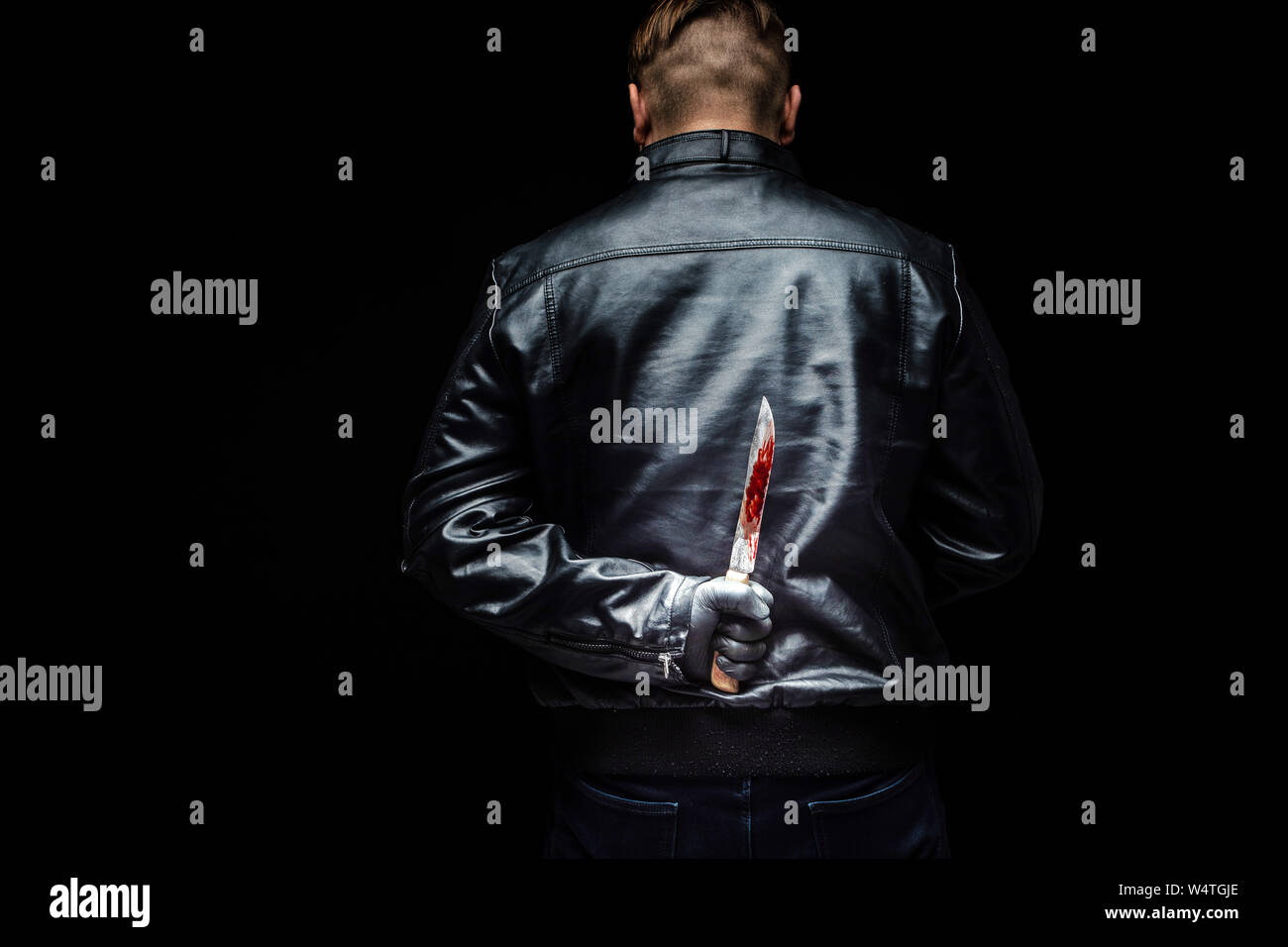 Serial killer maniac holding killer tools behind his back Stock Photo ...